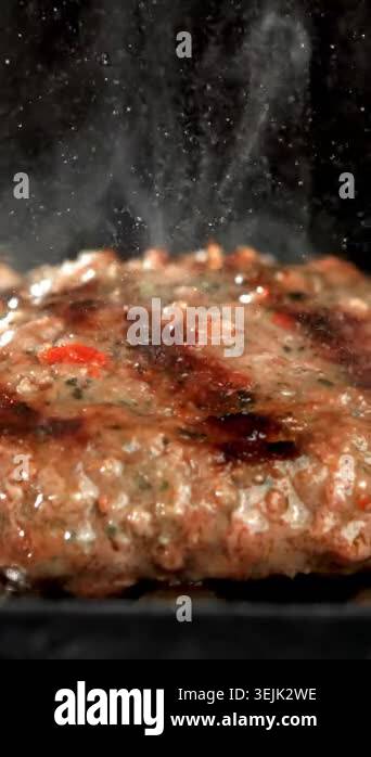 Beef burger in a skillet. Filmed on a high-speed camera at 1000 fps ...