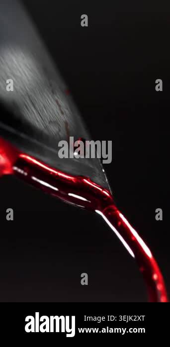 Blood dripping from the knife blade. Filmed on a high-speed camera at ...
