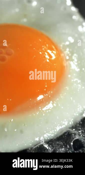 The egg is fried in a pan. Filmed on a high-speed camera at 1000 fps ...
