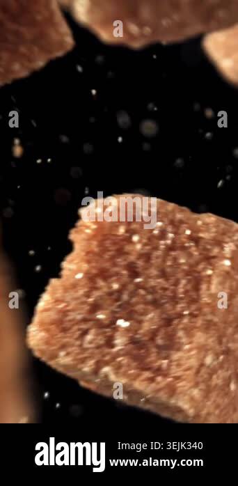 Cane sugar cubes fall down. Filmed on a high-speed camera at 1000 fps ...