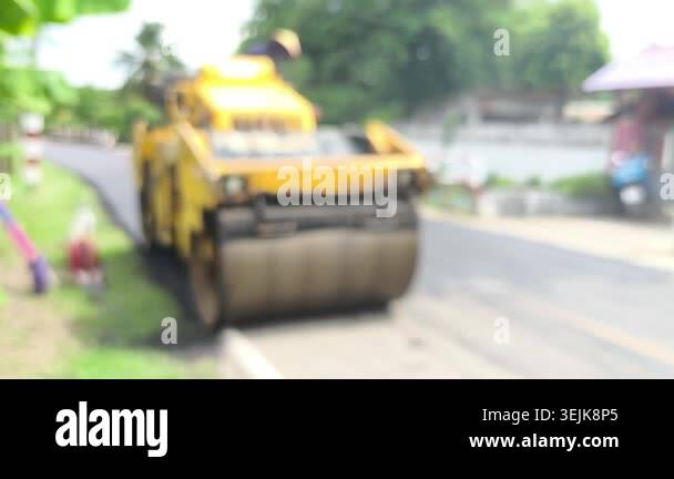 Blurred the road roller is compacting the asphalt, rural Chiangmai ...
