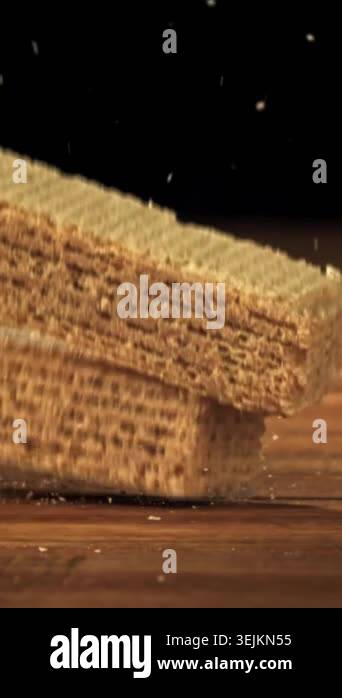 Waffles fall on a wooden table. Filmed on a high-speed camera at 1000 ...