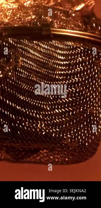 Strainer for brewing tea in hot water. Filmed on a high-speed camera at ...