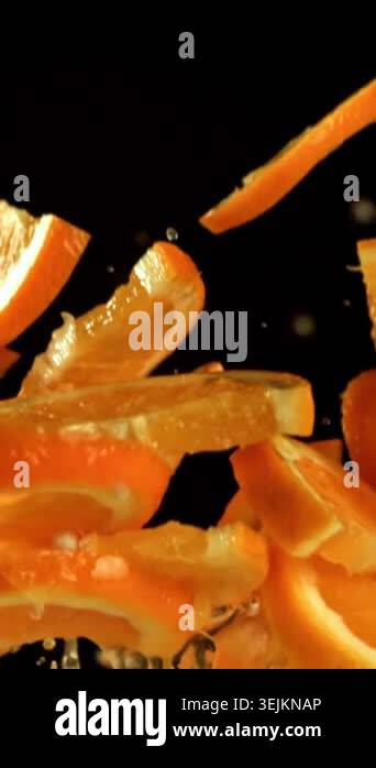 Orange slices flying on a black background. Filmed on a high-speed ...