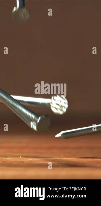 Nails fall on the carpenters worktable. Filmed on a high-speed camera ...