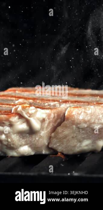 Tuna steak is fried in a pan. Filmed on a high-speed camera at 1000 fps ...