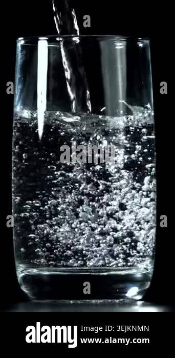 Water is poured into a glass. Filmed on a high-speed camera at 1000 fps ...