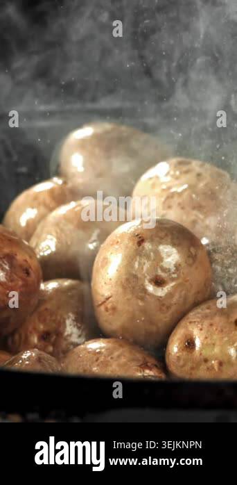 The potatoes are fried in a large frying pan. Filmed on a high-speed ...