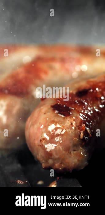 Sausages are fried in a pan with a splash of oil. Filmed on a high ...