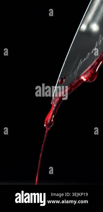 Blood dripping from the knife blade. Filmed on a high-speed camera at ...