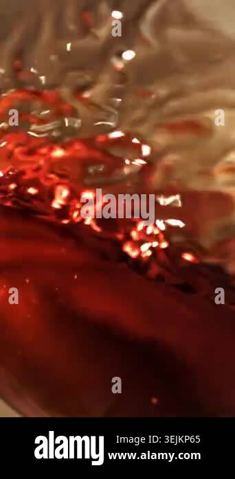 Aged cognac in a glass. Filmed on a high-speed camera at 1000 fps. High ...