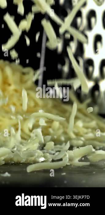 The grated cheese falls on the table. Filmed on a high-speed camera at ...