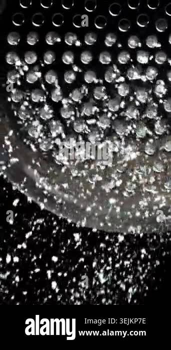 Salt is pouring out of the salt shaker. Filmed on a high-speed camera ...