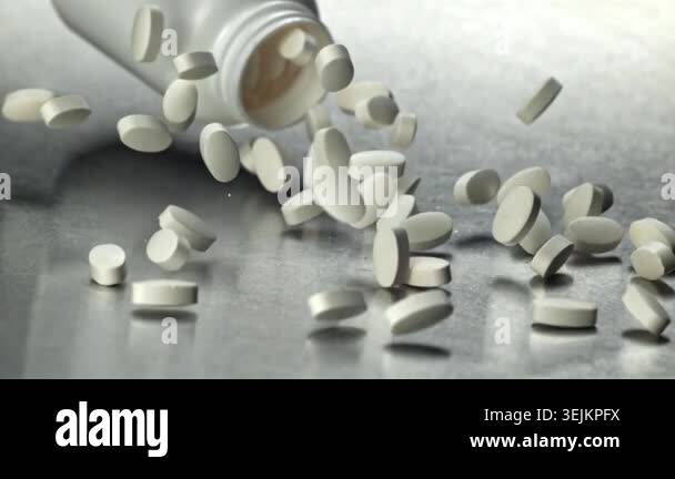 White tablets spilled from bottle on metal accidental spill scenario ...