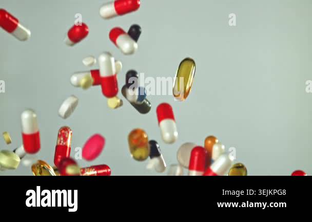 Assorted tablets and capsules floating softly in bright studio, clinic ...