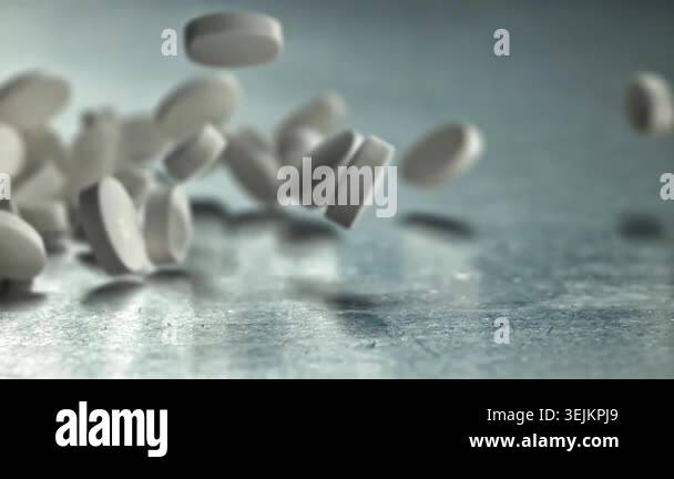 White overthecounter tablets tumbling across textured metal surface ...