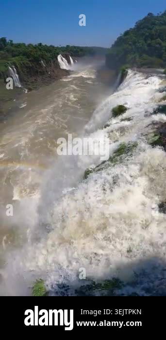 POV view of rushing water and mist with a visible rainbow over the ...
