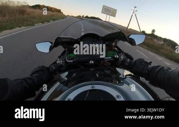Biker racing his motor bike during summer journey. Point of view of a ...