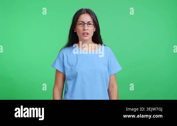 Young brunette woman with glasses experiencing poor vision and eye ...