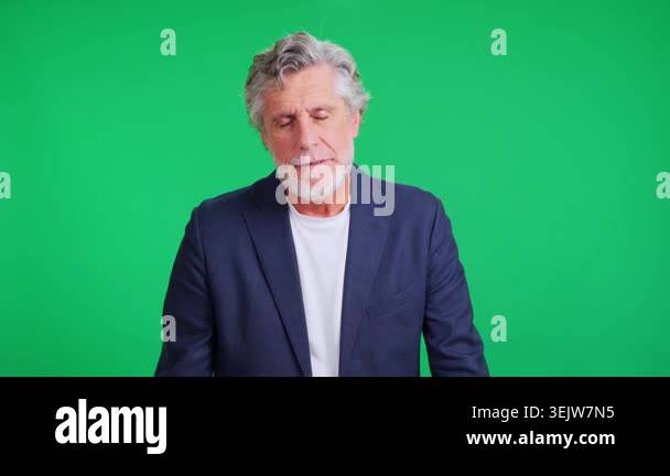 Senior man with a beard feeling displeased against a chroma key ...