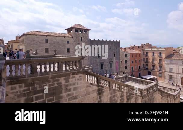 Panning shot revealing the historical stone buildings and stairs in the ...