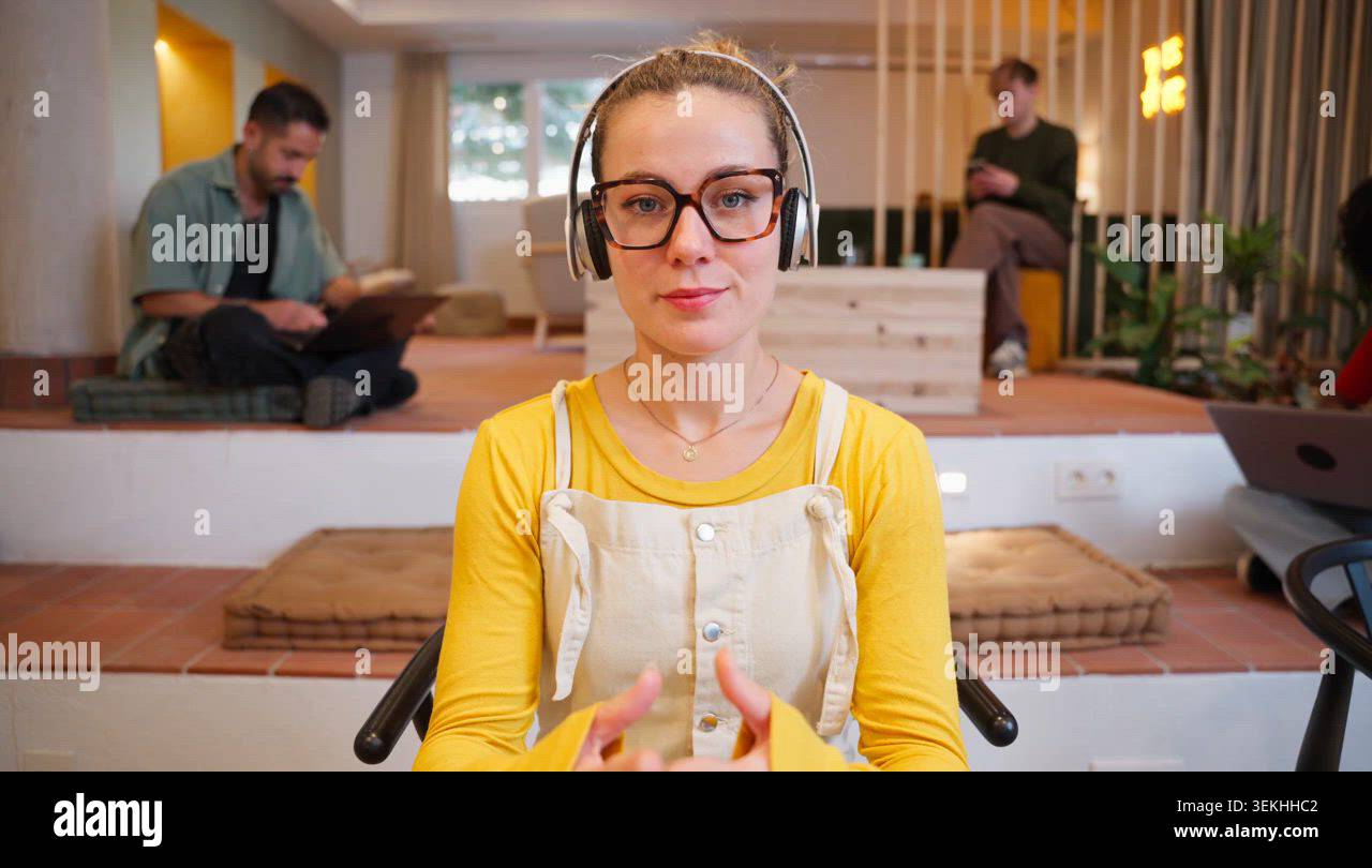 Young female vlogger gesturing and speaking to the camera Stock Video ...