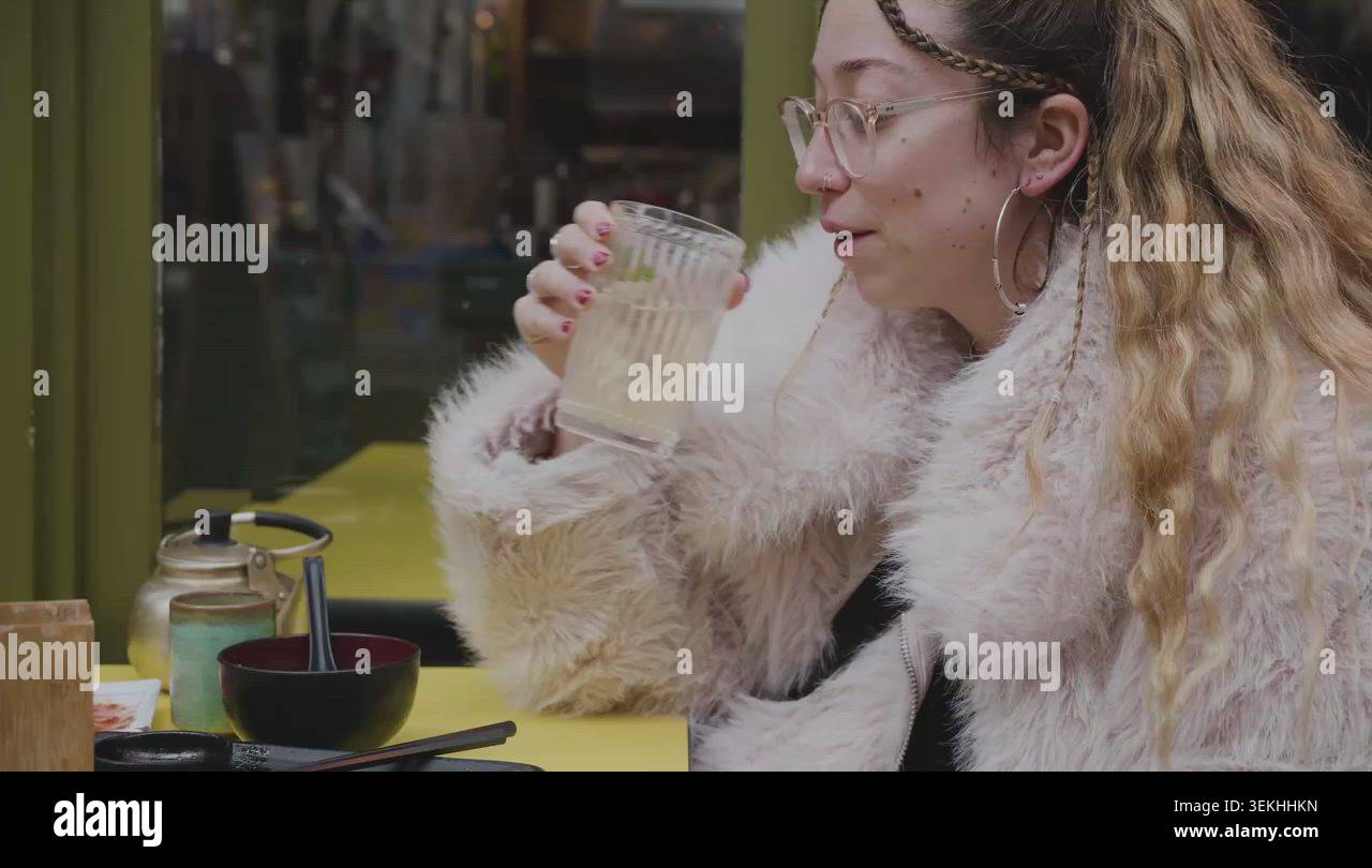 Beautiful woman drinking lemonade in restaurant Stock Video Footage - Alamy