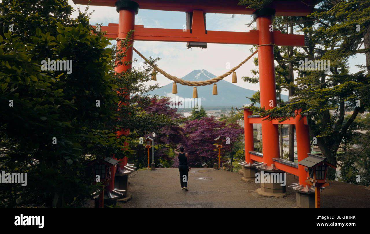 Traveler walking through torii gate in Arakurayama Sengen Park, Japan ...