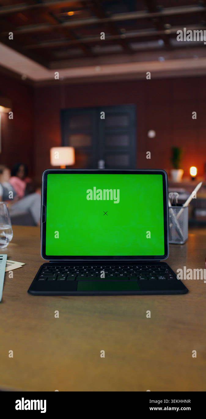 A laptop with green screen on the table Stock Video Footage - Alamy