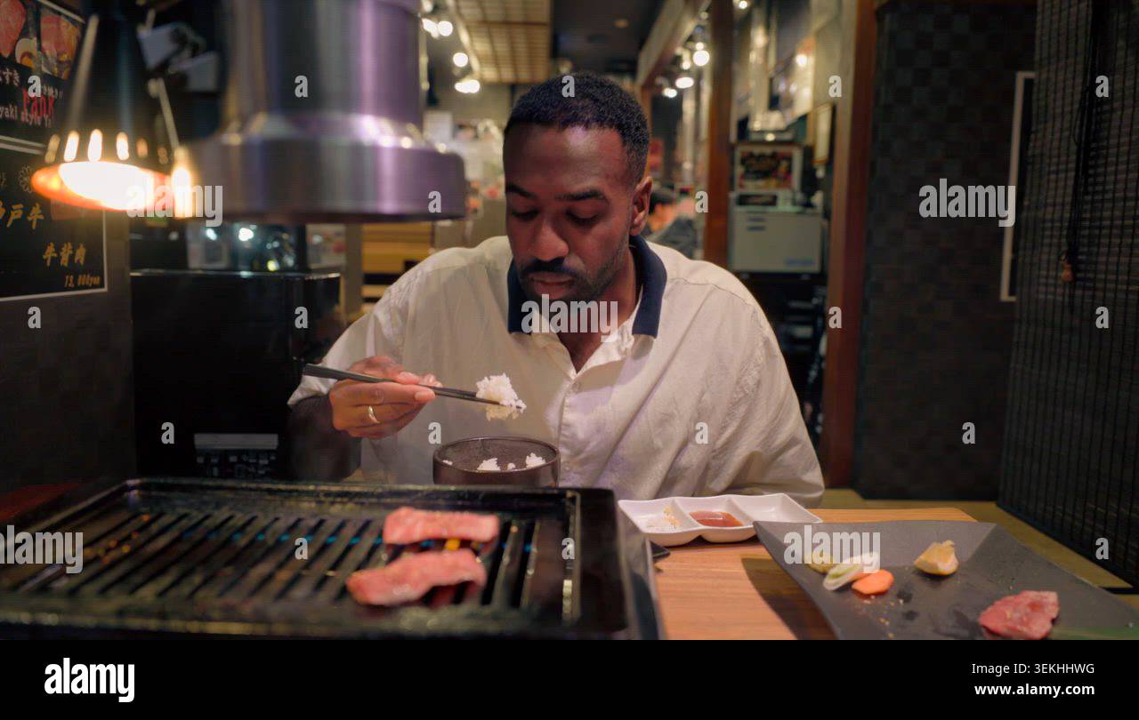 Man eating at Japanese grill restaurant Stock Video Footage - Alamy