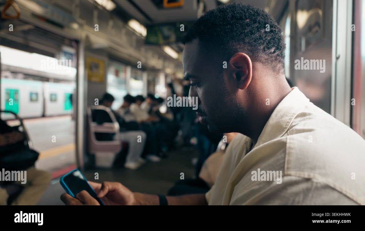 Commuter using phone in Tokyo Stock Video Footage - Alamy