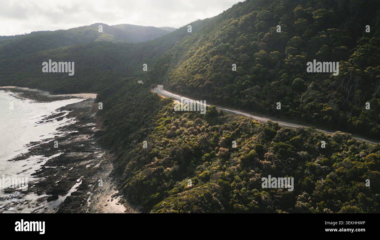 Coastal road meandering through green hills near the ocean Stock Video ...