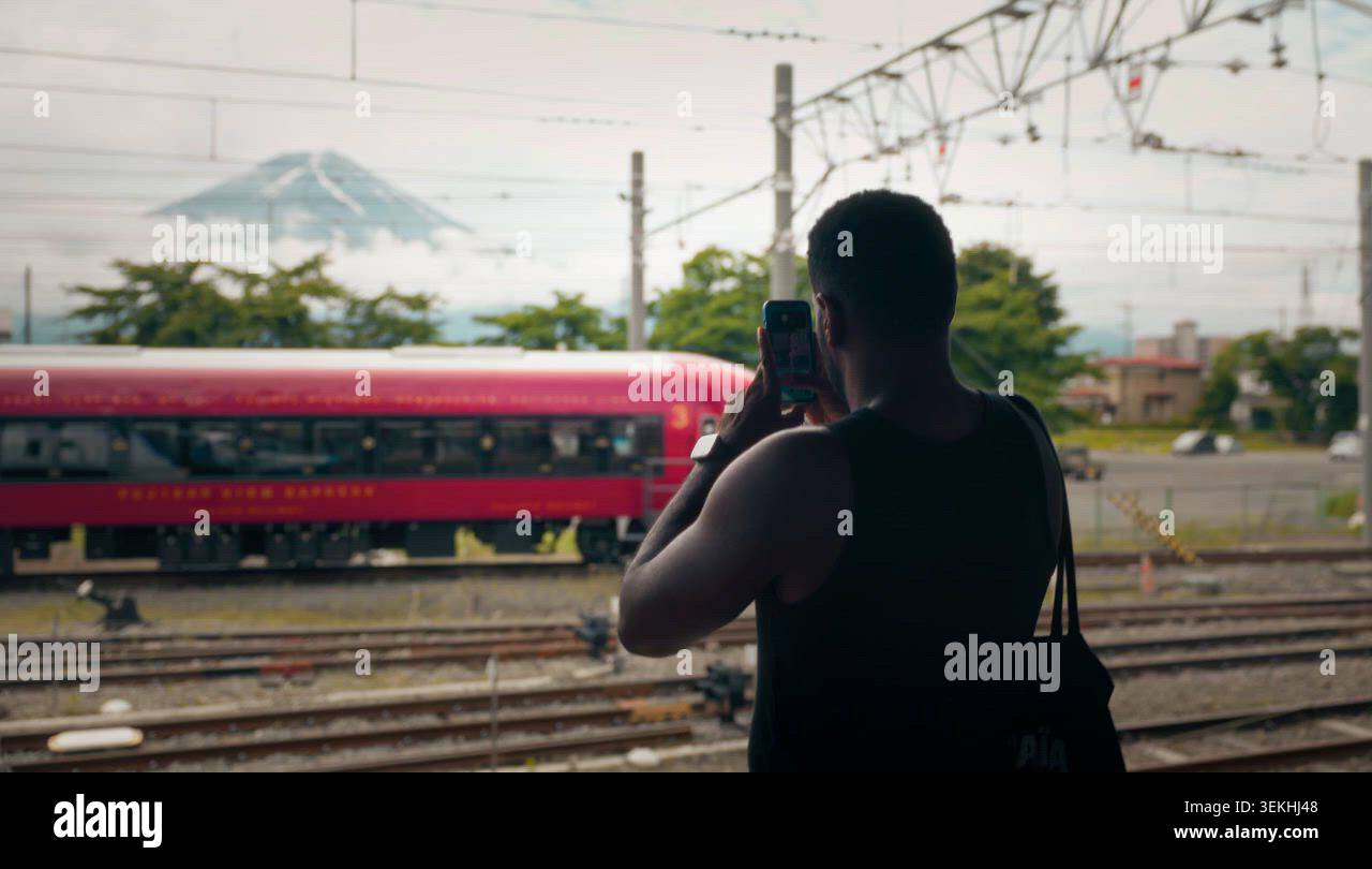 Traveler photographing Mount Fuji from train platform Stock Video ...
