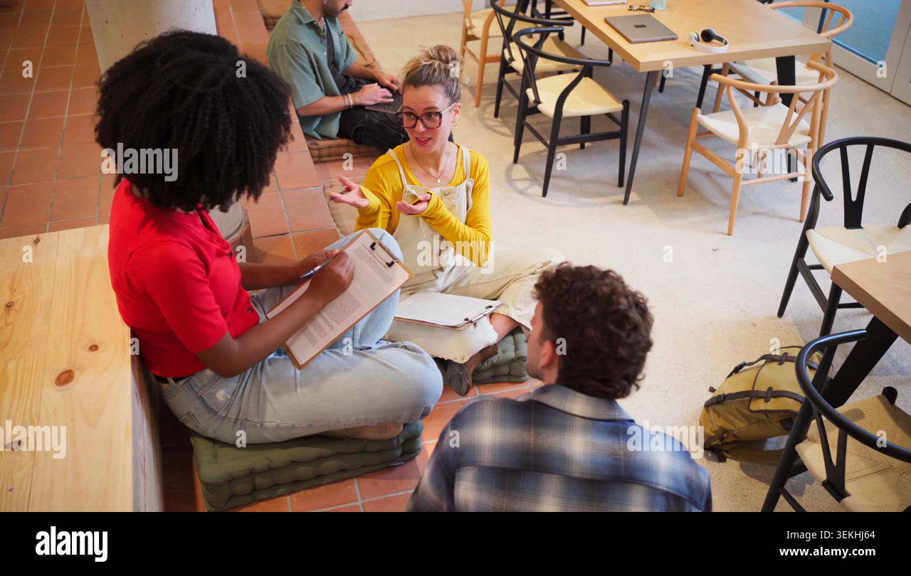 Diverse students sitting on the floor brainstorming ideas Stock Video ...