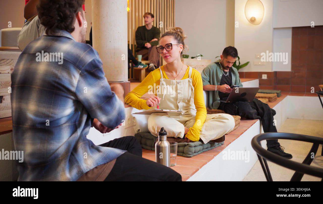 Young creative professionals collaborating in a modern coworking space ...