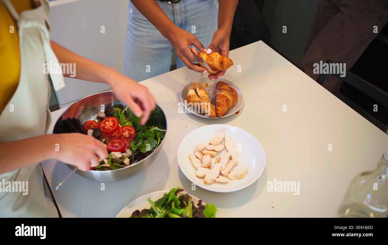 Two women preparing a fresh healthy salad and sandwiches Stock Video ...