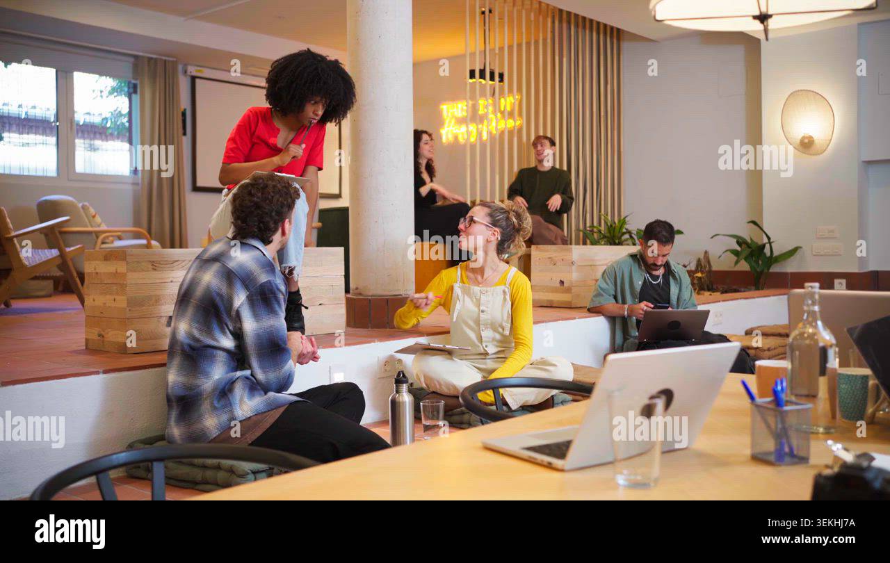 Young creative professionals collaborating in a modern coworking space ...