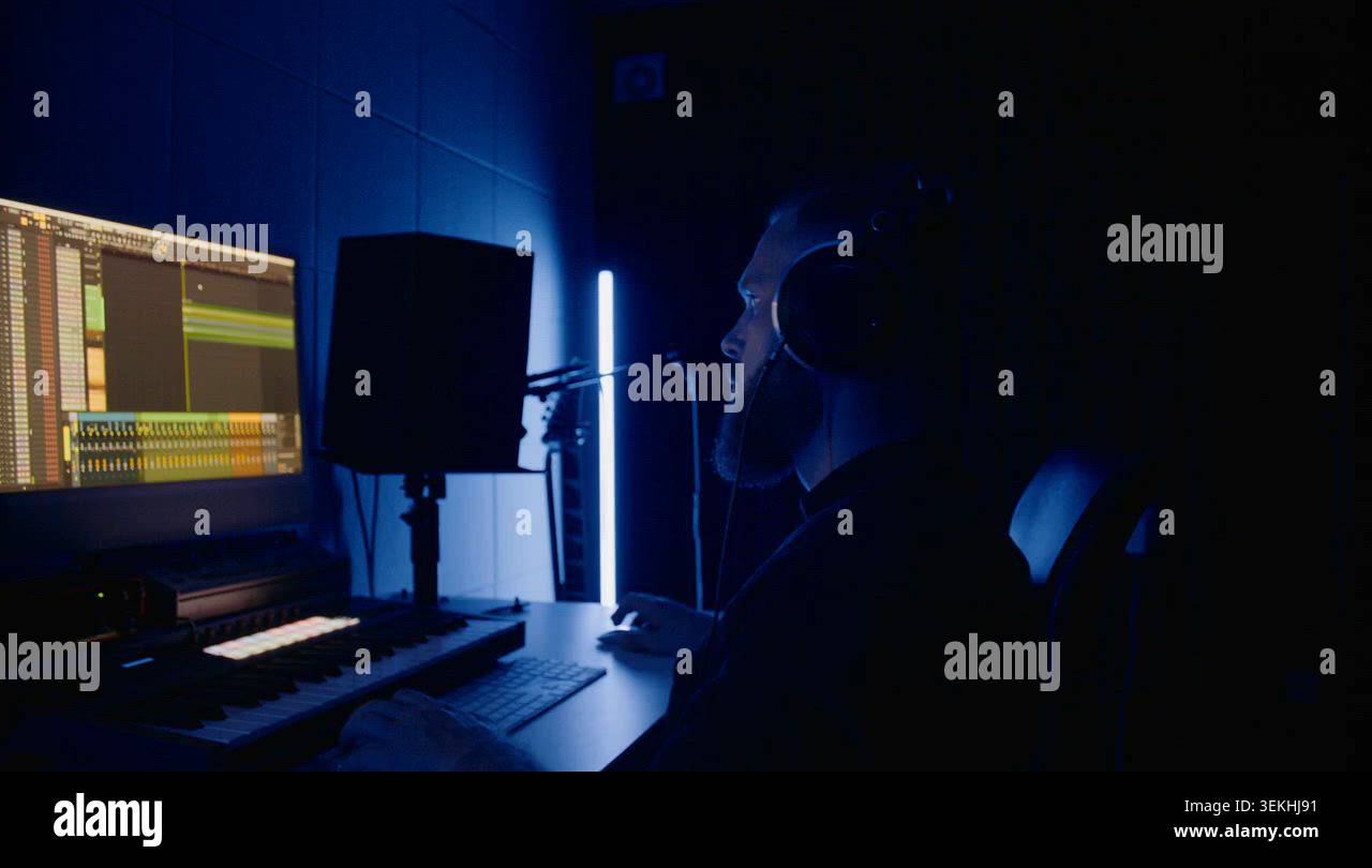 Music Production in a Dark Studio at Night With a Man Working Stock ...