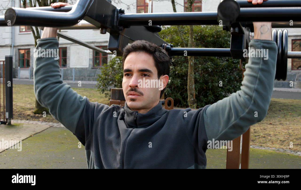 Man Performing Shoulder Press on Resistance Machine at Outdoor Gym ...