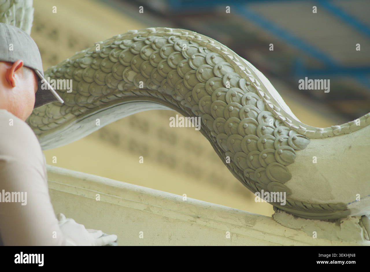 6K open gate: artisan shaping naga scale on cement sculpture Stock ...
