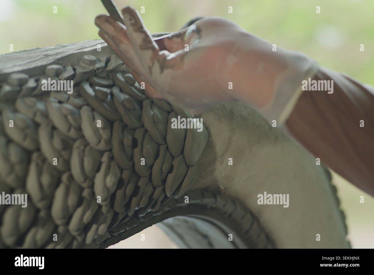 6K open gate: artisan shaping naga scale on cement sculpture Stock ...