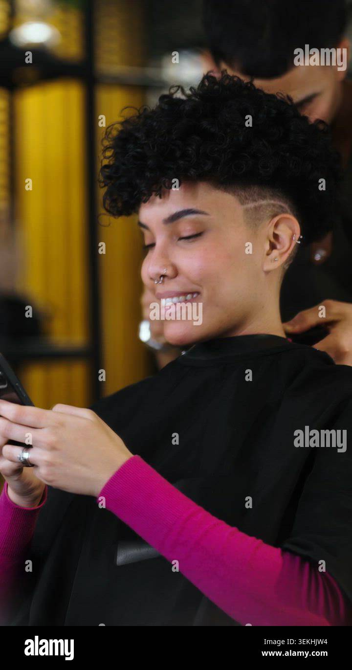 Lady phones in haircut Stock Video Footage - Alamy