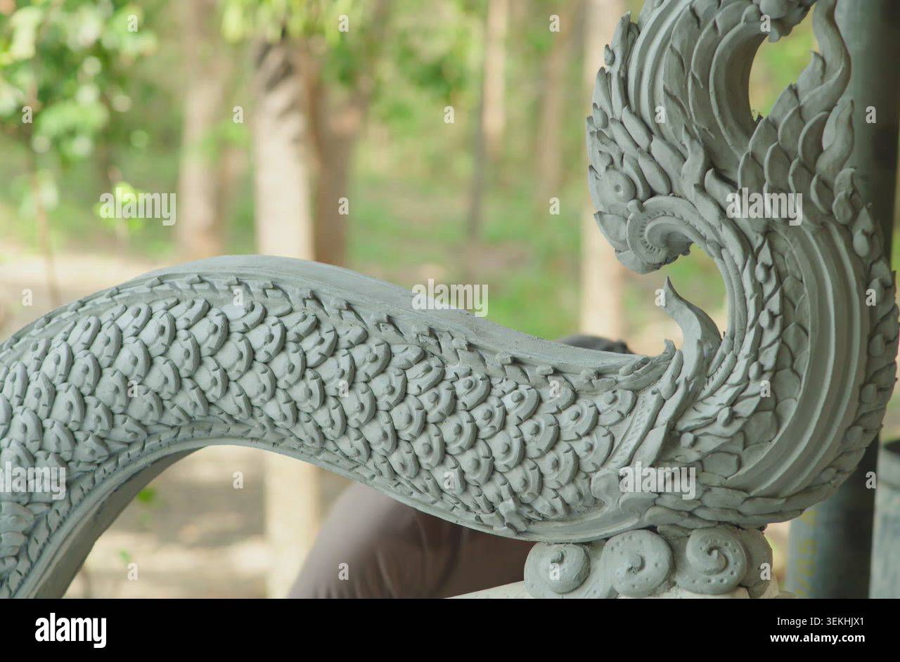 6K open gate: artisan shaping naga scale on cement sculpture Stock ...