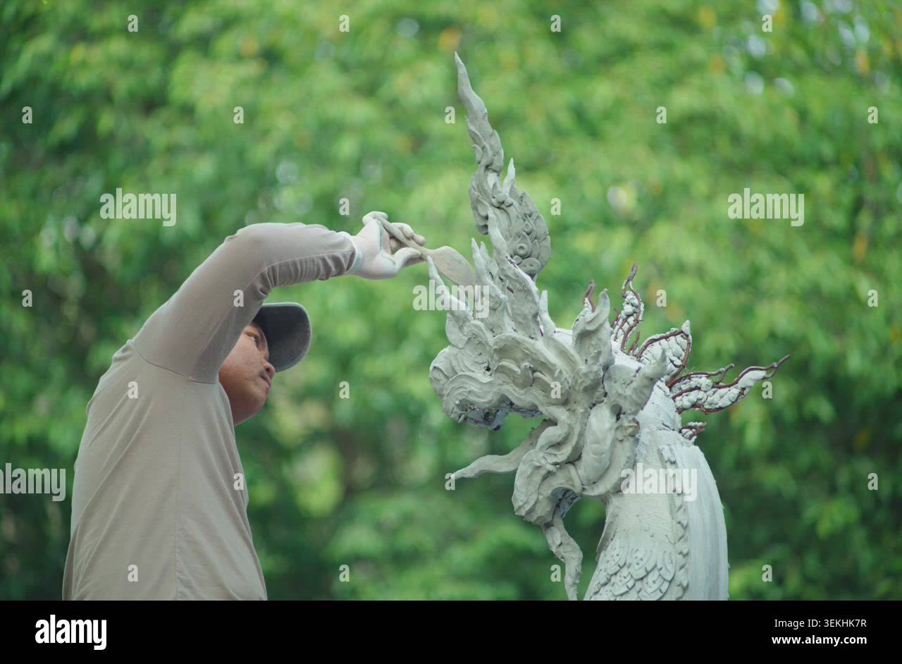 6K open gate: Thai artisan sculpting naga cement sculpture Stock Video ...