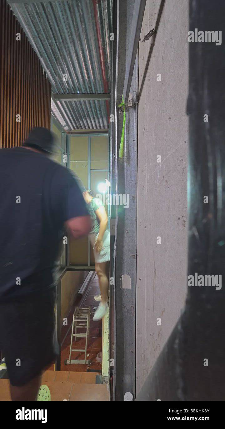 Workers install wooden slat wall panels during the renovation Stock ...