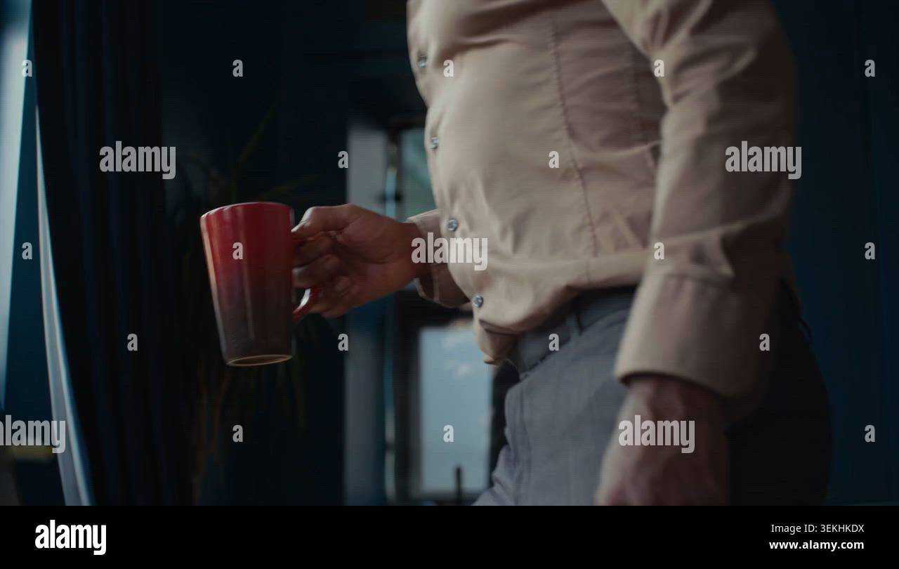 man sitting down to work at a laptop with a coffee Stock Video Footage ...