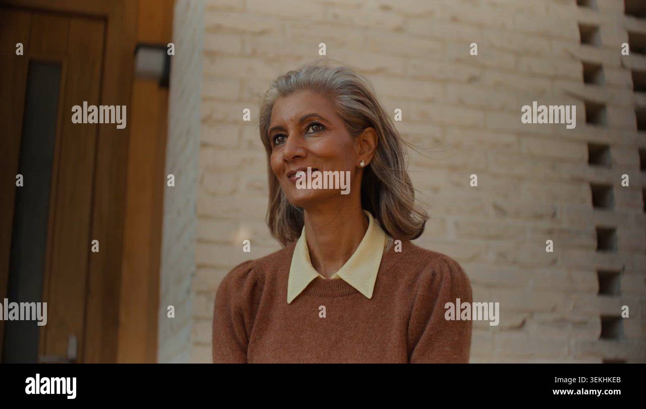 Elderly Woman smiling While sitting in Front of Brick Wall Stock Video ...