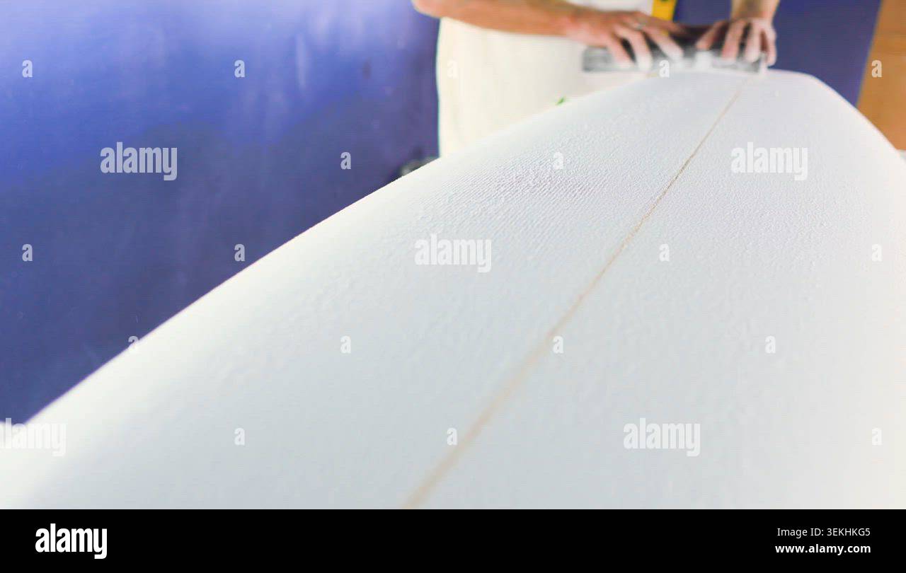 Handheld close-up of surfboard shaper sanding foam blank Stock Video ...