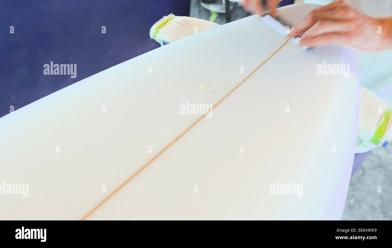 Static handheld shot of shaper planing stringer at surfboard nose Stock ...
