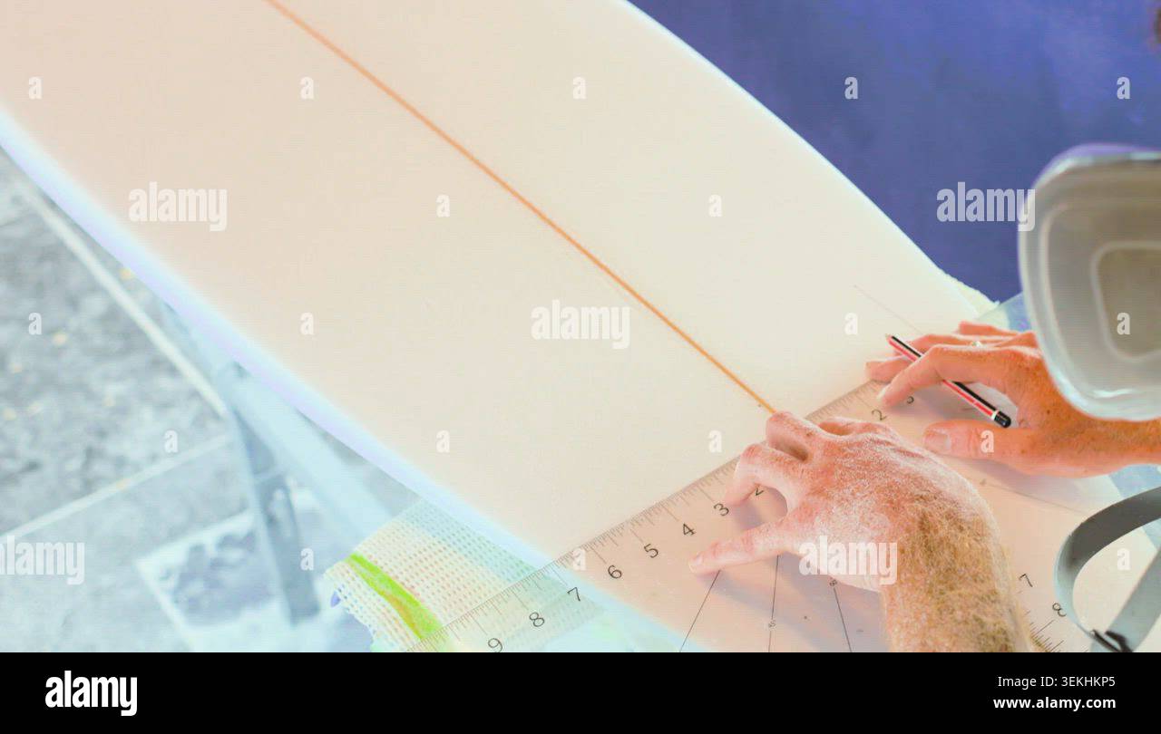 Static handheld overhead shot of shaper measuring tail for fin placeme ...